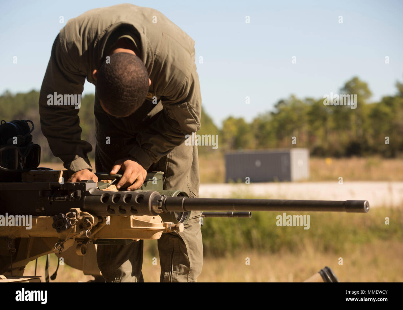 A Marine performs last minute checks on a .50 caliber machine gun ...