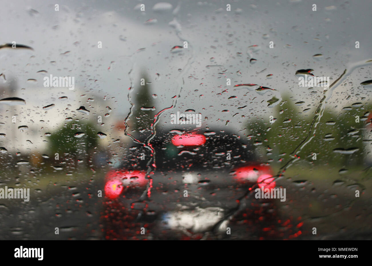 Dangerous vehicle driving in heavy rain. Poor visibility, falling rain ...