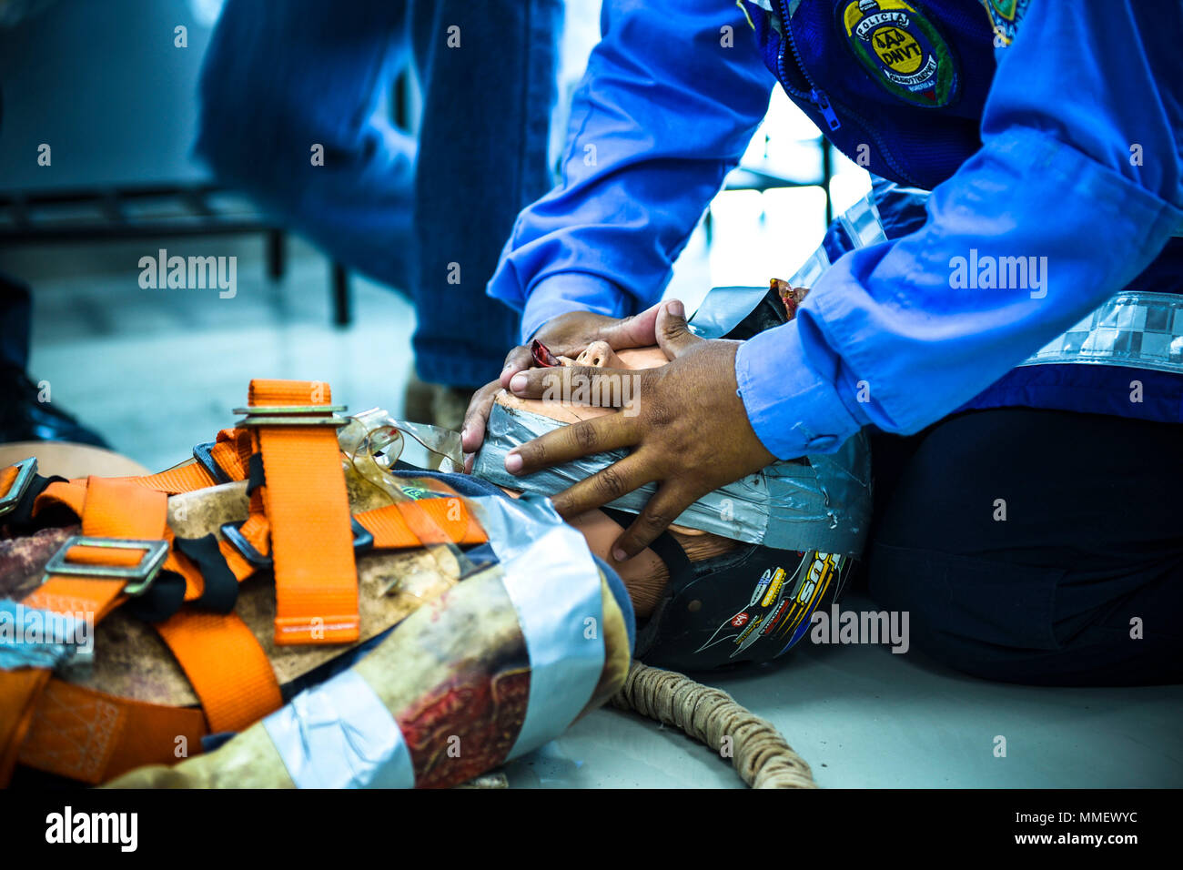 A Honduran police officer practices how to stabilize a patient during a ...