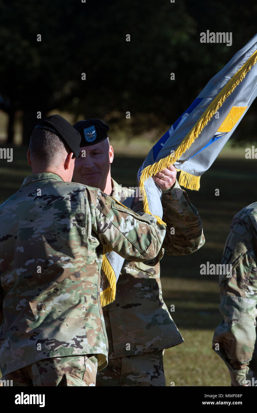 Col. Stephen Aiton, Soldier Support Institute commander, hands the ...