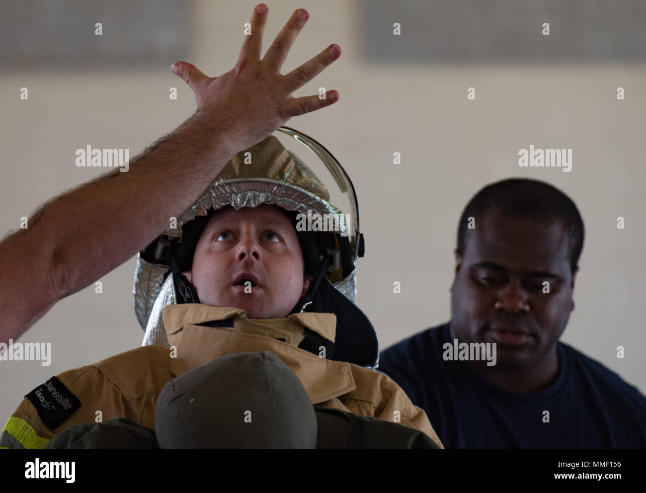 A participant competes in the 145-pound-dummy drag obstacle during the ...