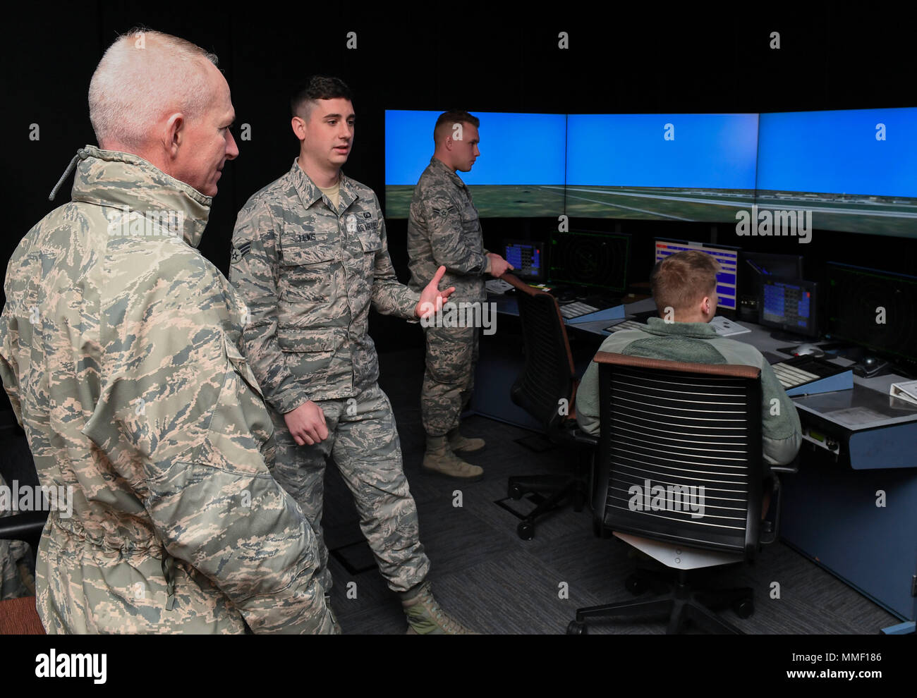 From left, Chief Master Sgt. Alan Boling, Eighth Air Force command chief, listens to a briefing ...