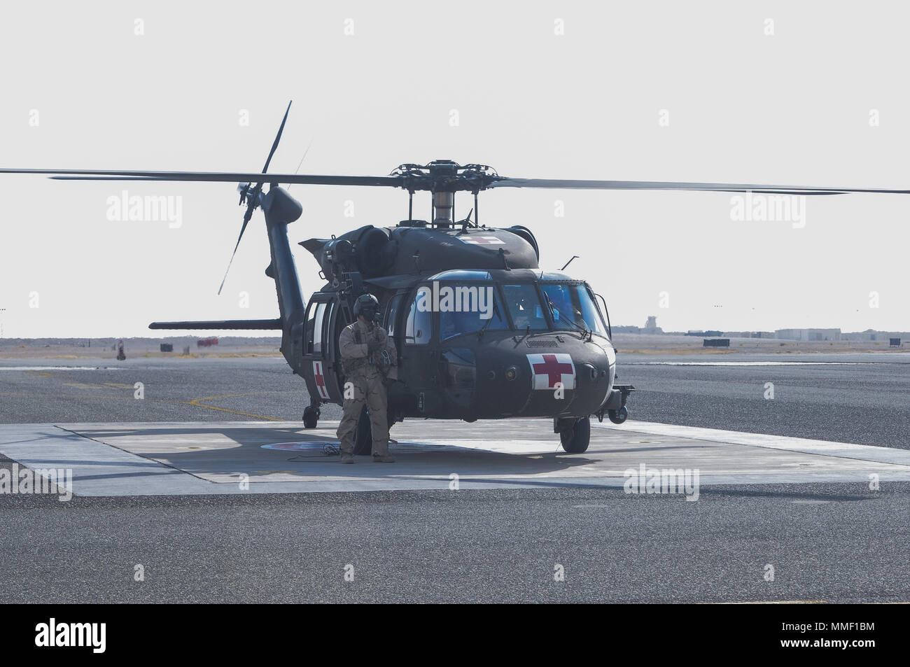 CAMP BUEHRING, Kuwait – A crew chief from Task Force Wraith assists ...