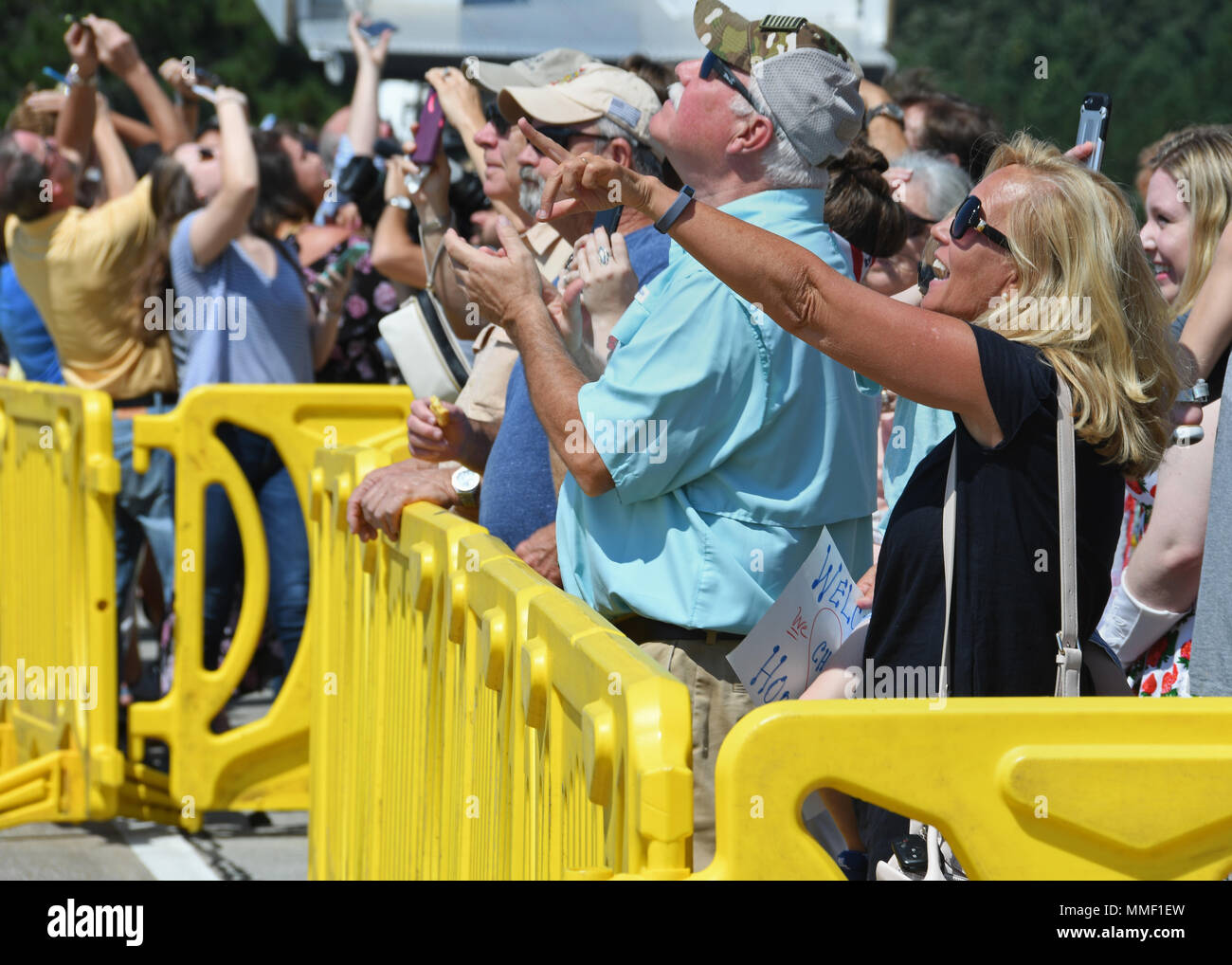 Families and friends of returning Deployers point up as five C-130 H3 ...
