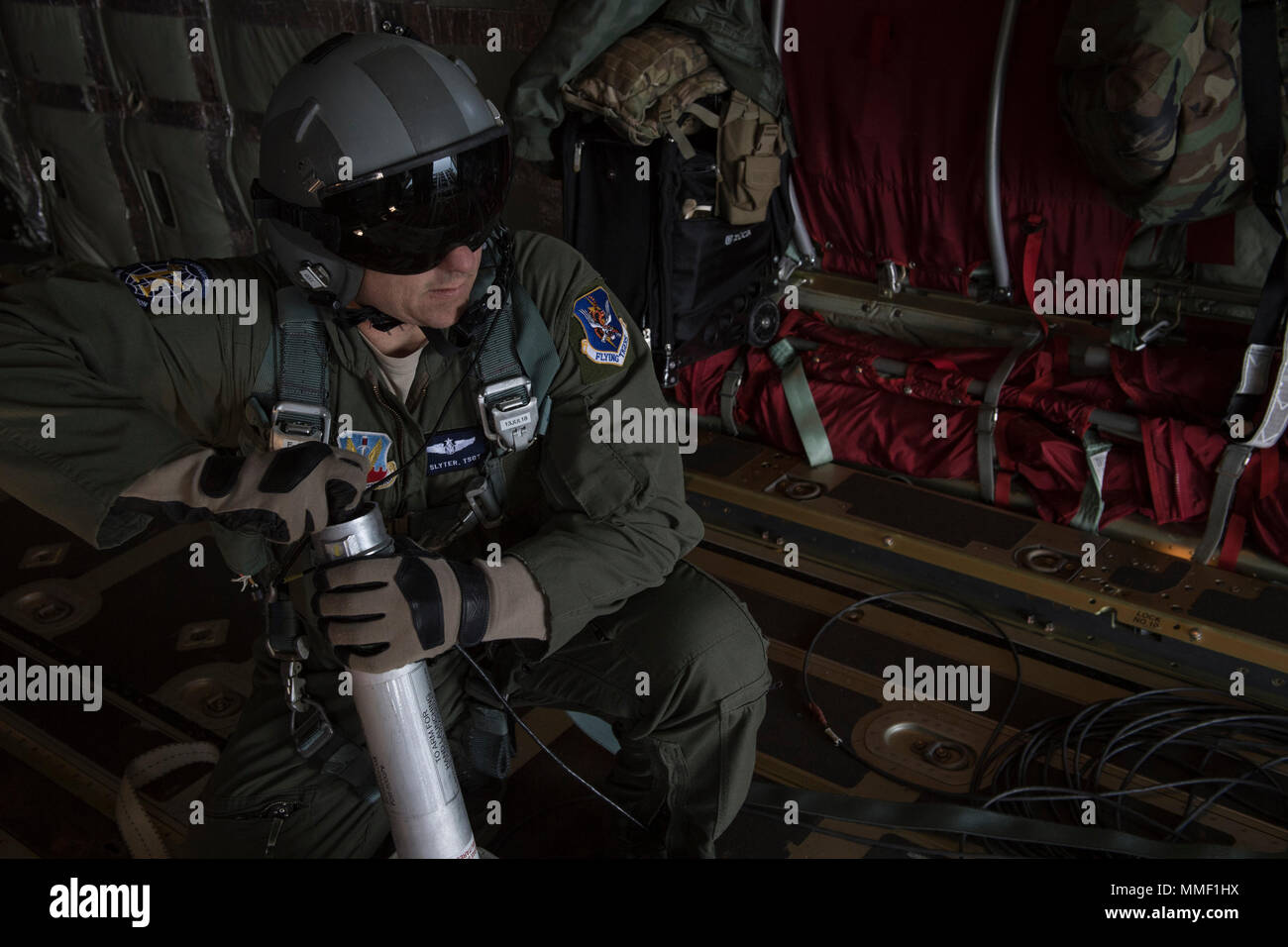 Tech. Sgt. Brent Slyter, 71st Rescue Squadron loadmaster, prepares a flare, Oct. 31, 2017, over ...