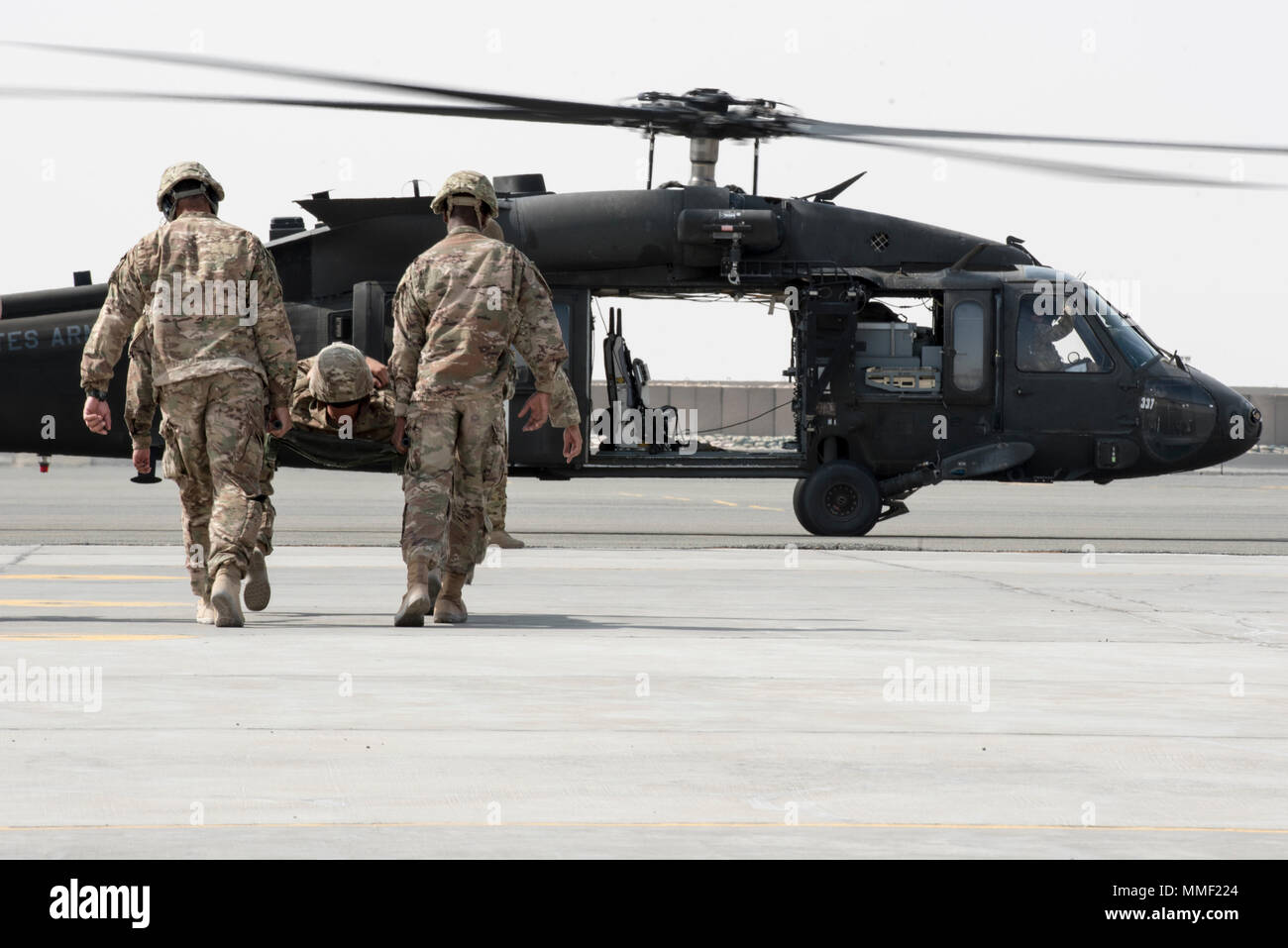 Soldiers practice loading a casualty into a UH-60 Blackhawk helicopter ...