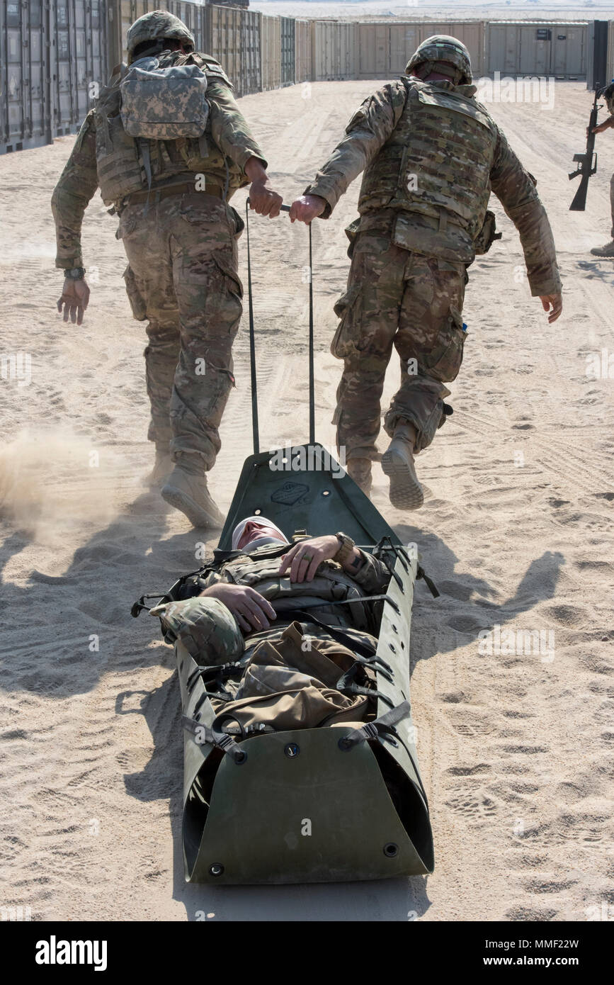 Soldiers participating in Combat Lifesaver training drag a simulated ...