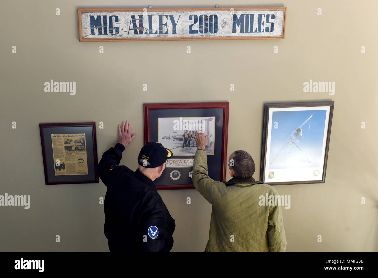 Max Garland (left), Korean War veteran, views a picture of a MiG Alley ...