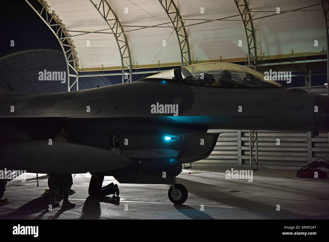 Crewmembers perform a post flight check on an F-16 Fighting Falcon at ...