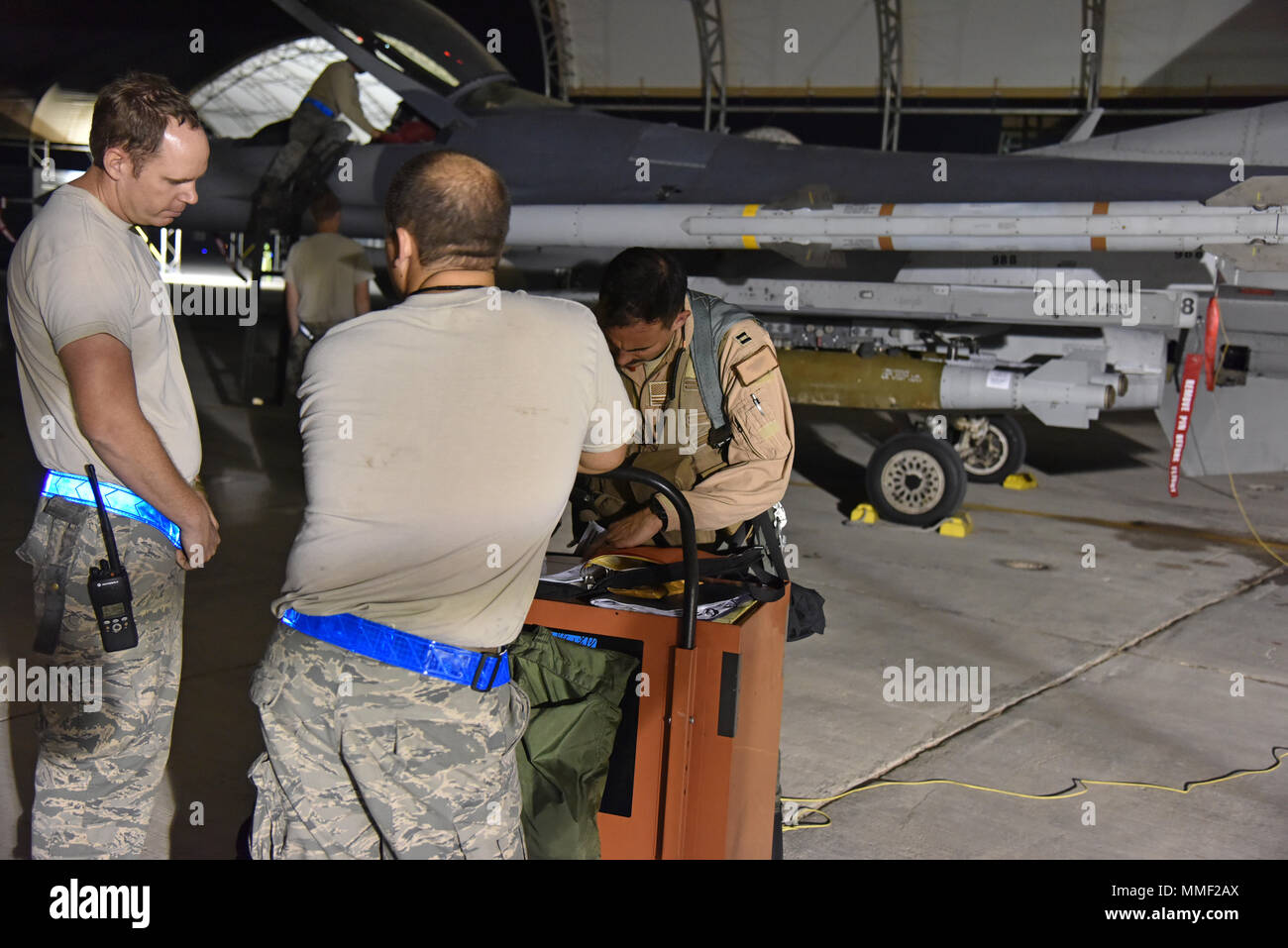 An F-16 Fighting Falcon pilot fills out his post flight paperwork at ...
