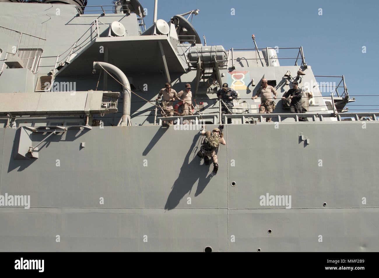 A U.S. Navy Special Operations Forces member scales a ship Oct. 19 ...