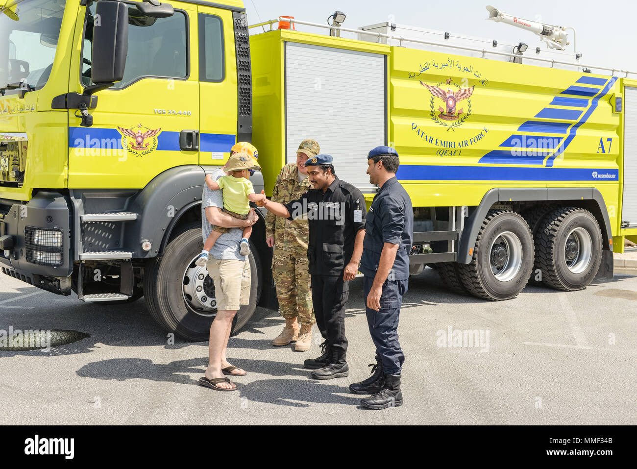 A firefighter from the Qatari Emiri Air Force shakes the hand of a ...