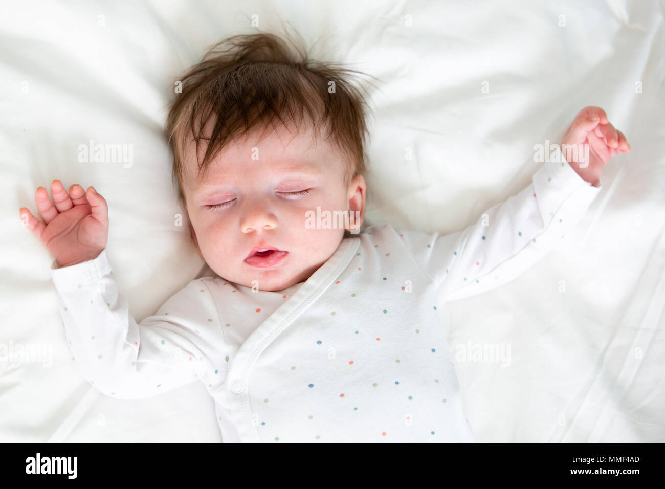 cute baby with dotted body is lying in bed Stock Photo - Alamy