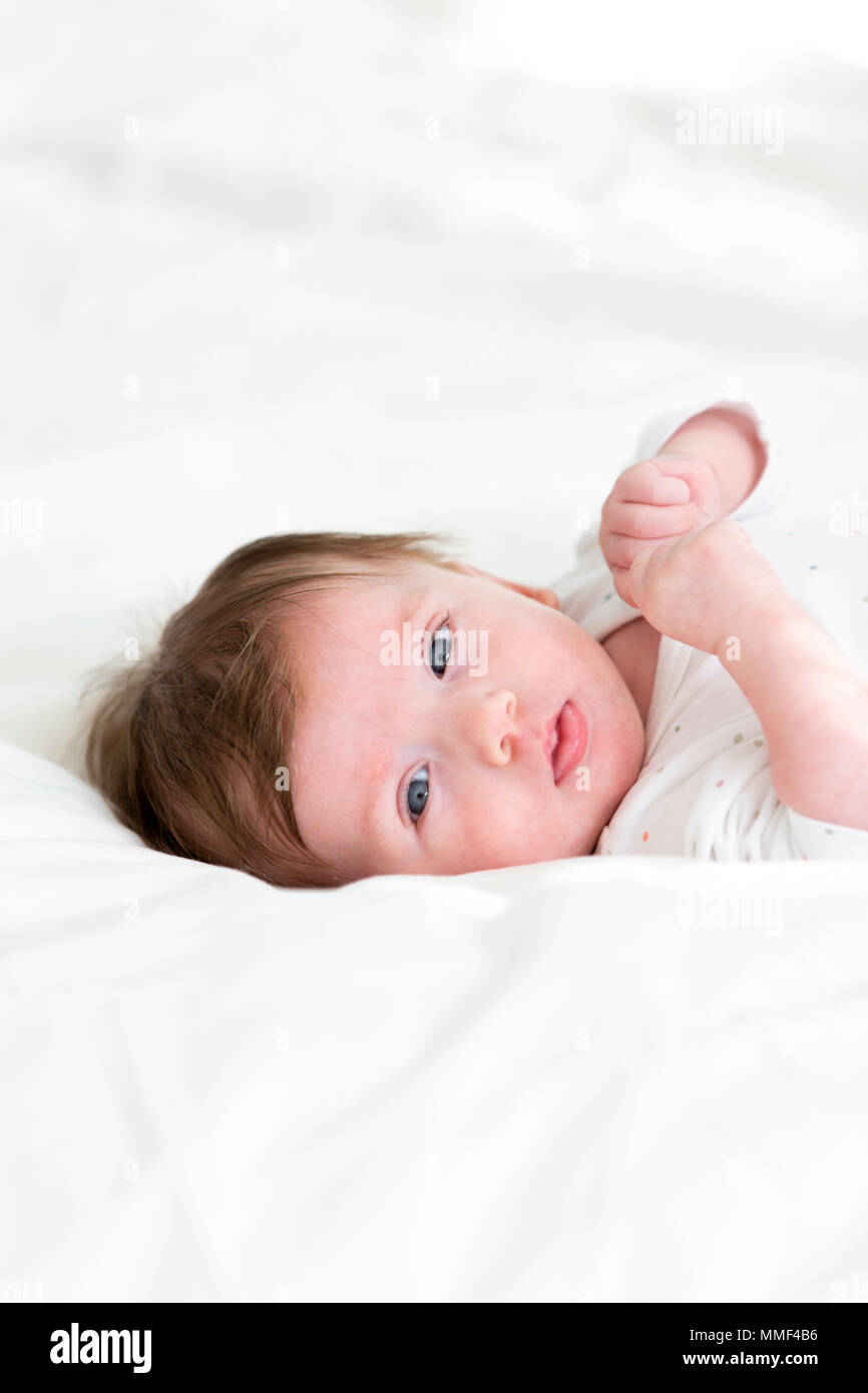 cute baby with dotted body is lying in bed Stock Photo - Alamy