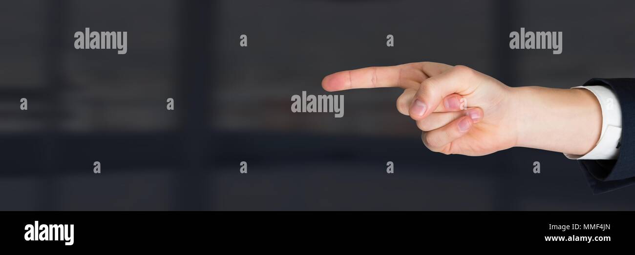 Hand pointing on dark background Stock Photo - Alamy
