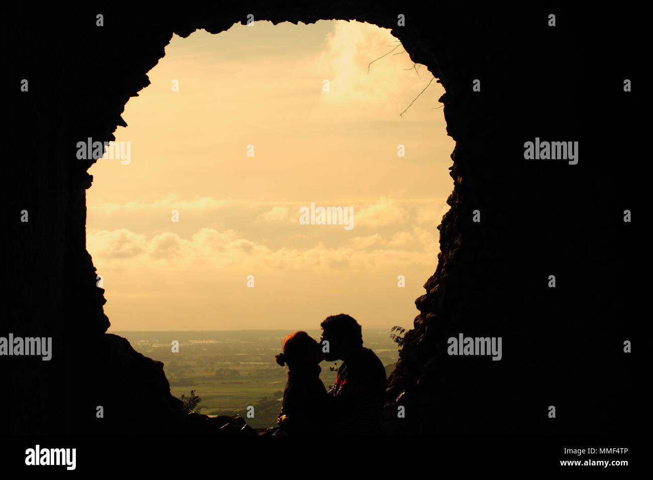 boyfriends kissing at sunset Stock Photo - Alamy