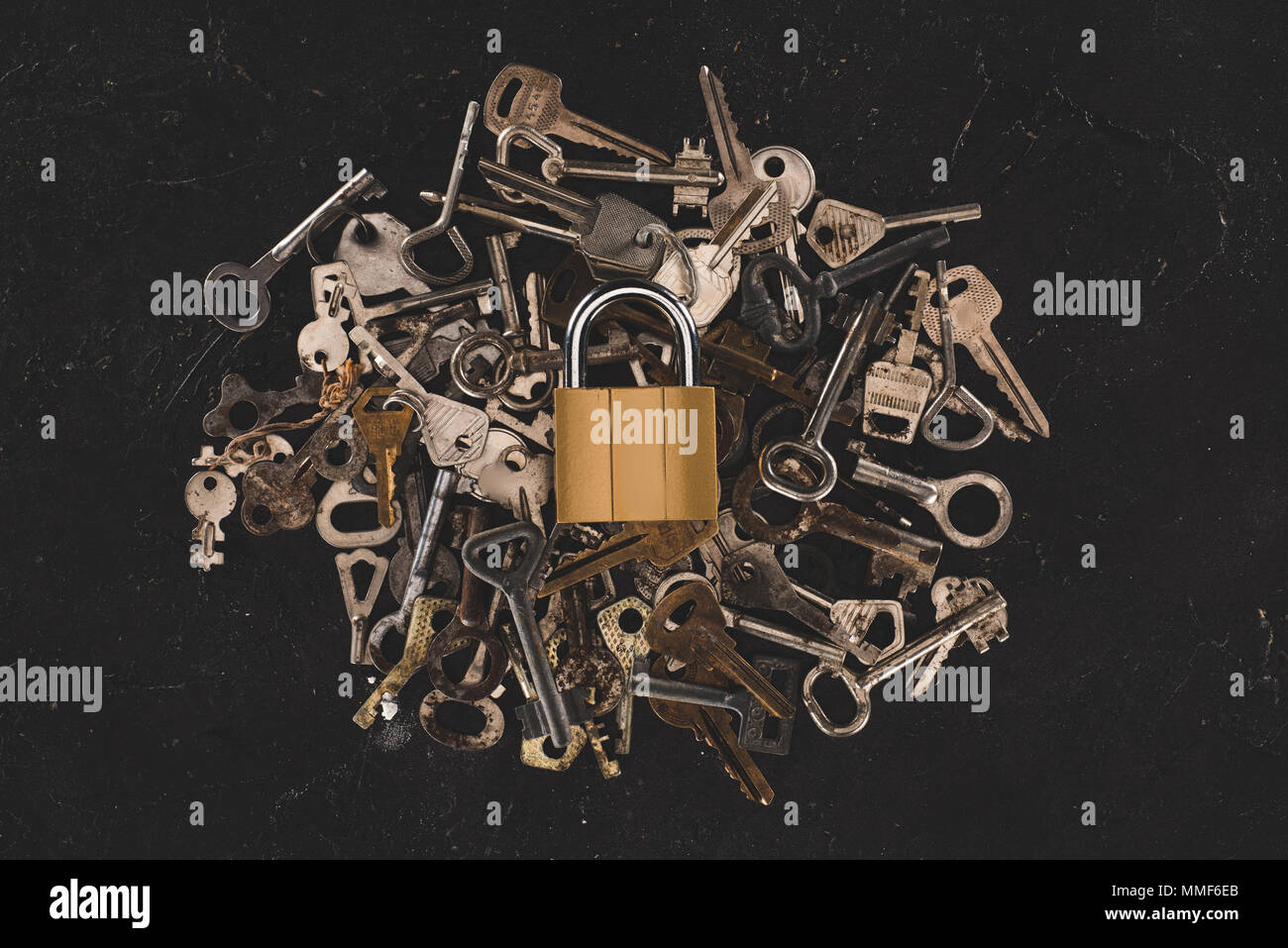 top view of heap different metal keys with lock isolated on black Stock ...