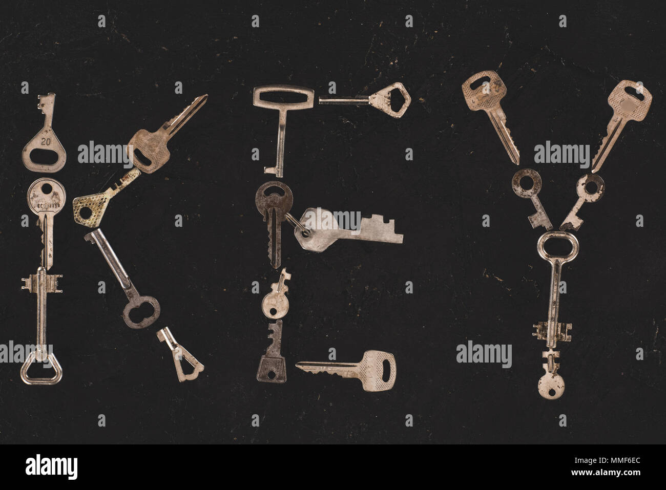 top view of metal keys forming word isolated on black Stock Photo - Alamy