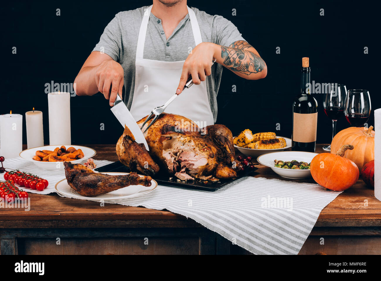 Man cutting turkey on thanksgiving day Stock Photo - Alamy