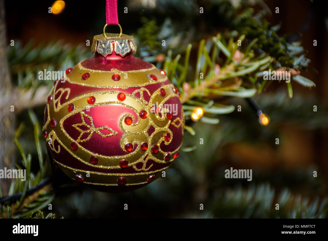 Christmas background - bauble, lights and branch of spruce tree Stock ...