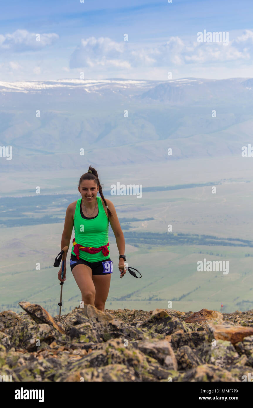 Female running in mountains under sunlight in Altay, Russia Stock Photo ...
