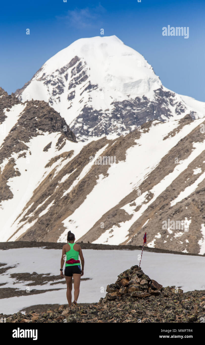Female running in mountains under sunlight in Altay, Russia Stock Photo ...