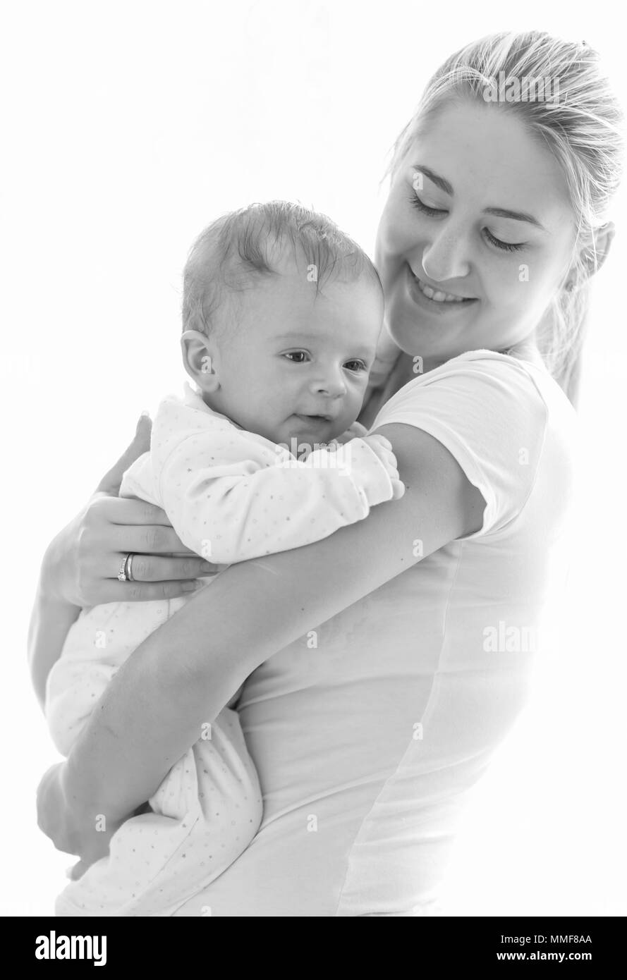 Black and white isolated portrait of young mother hugging her baby ...