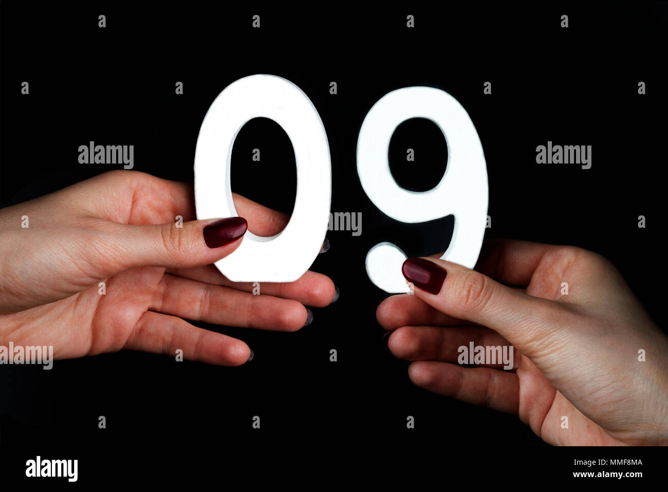 On a black background, female hand with number zero and nine Stock ...