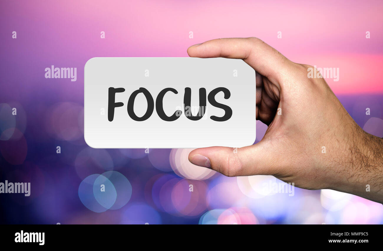 Hand holding placard with word FOCUS. Photo stock Stock Photo - Alamy