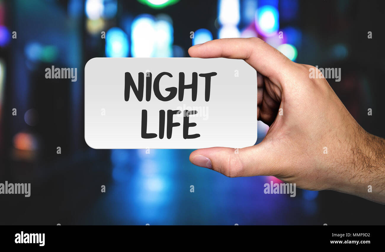 Hand holding placard with word NIGHT LIFE. Photo stock Stock Photo - Alamy
