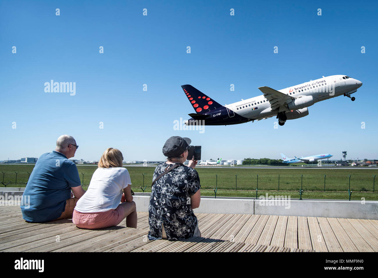 Plane spotters on aircraft spotting platform watching airplane from ...