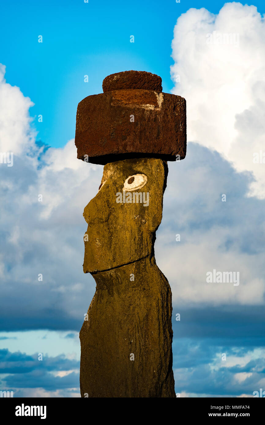The human figure of a Moai statue wearing a topknot on the coast of ...
