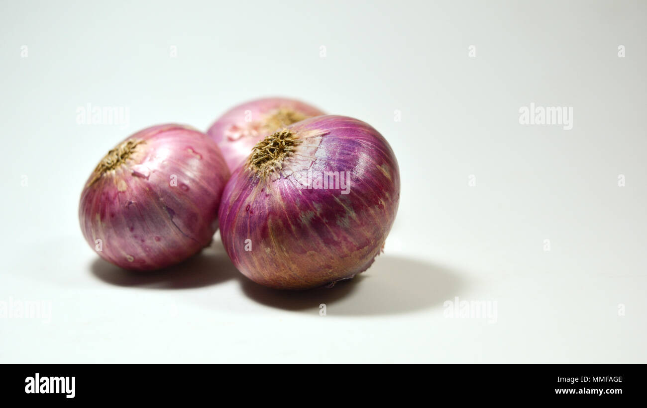 three onion set isolated on white background Stock Photo - Alamy