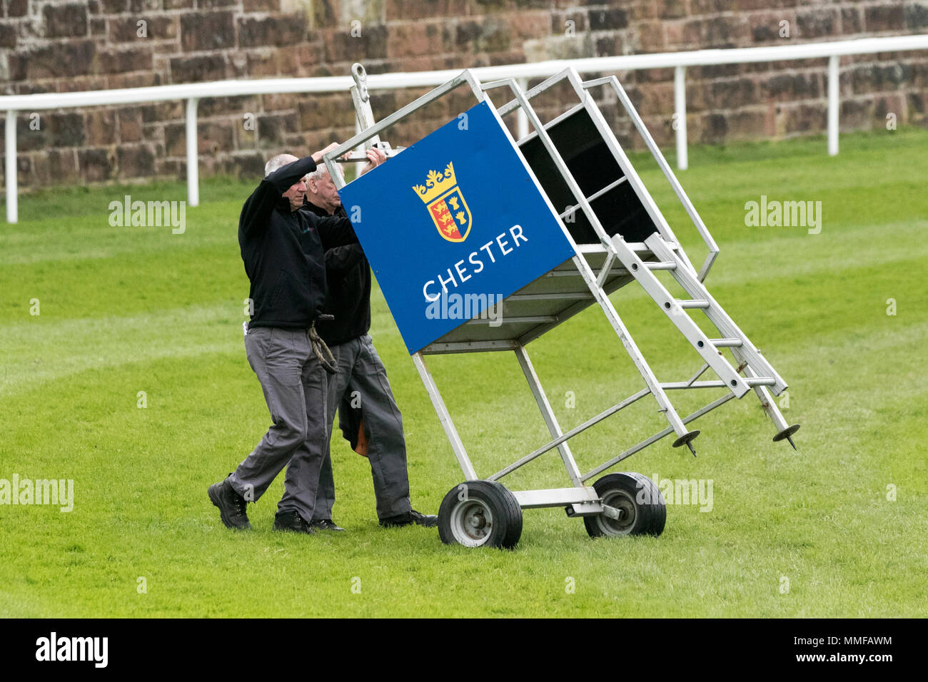 The starting stalls being checked and prepared for horse racing on the ...