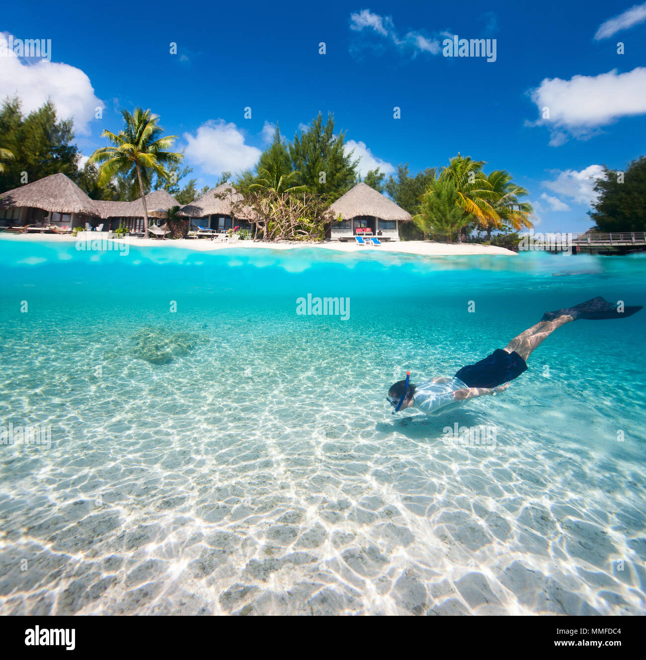 Man swimming in a tropical lagoon in front of exotic island Stock Photo ...