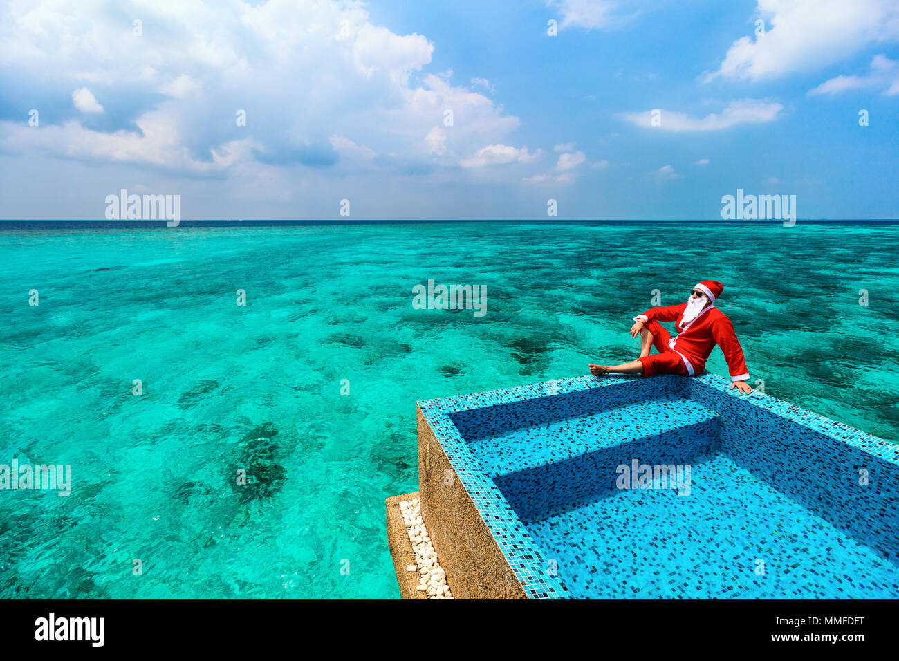 Christmas Santa Claus at tropical ocean luxury resort Stock Photo - Alamy