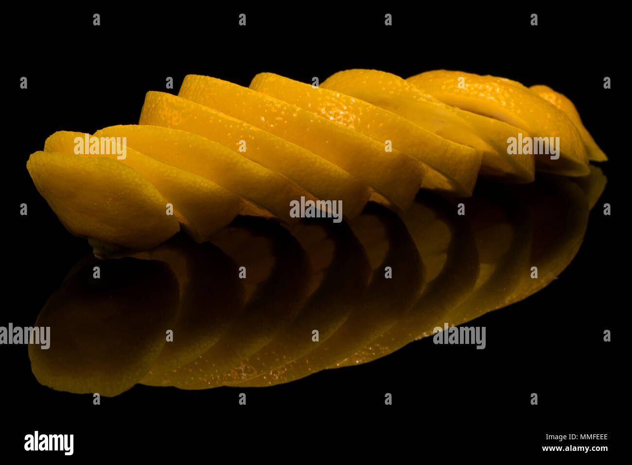 the lemon cut on segments isolated on a black background with ...