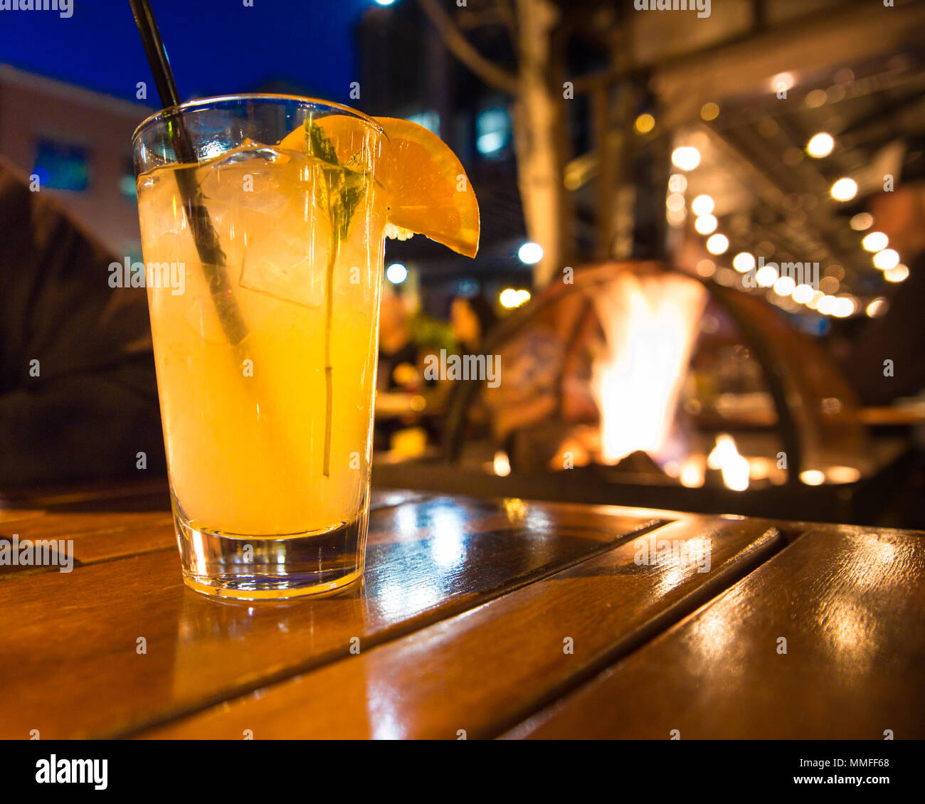 Refreshing cocktail beverage with ice and straw scene from outdoor ...