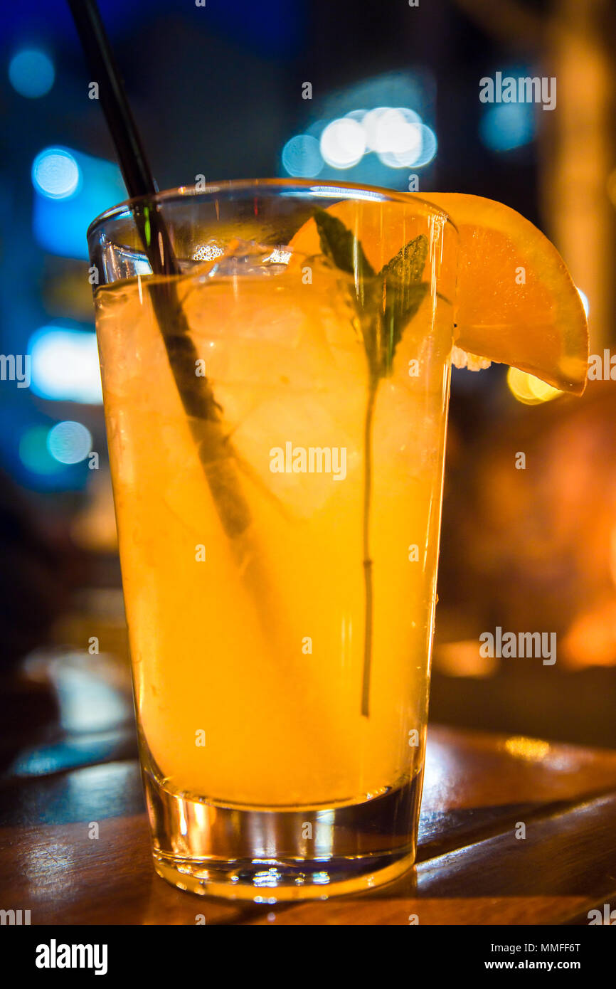 Refreshing cocktail beverage with ice and straw scene from outdoor ...