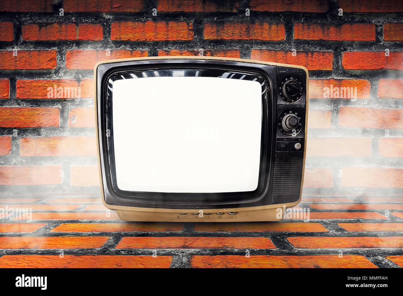 Retro TV isolated on brick wall background Stock Photo - Alamy
