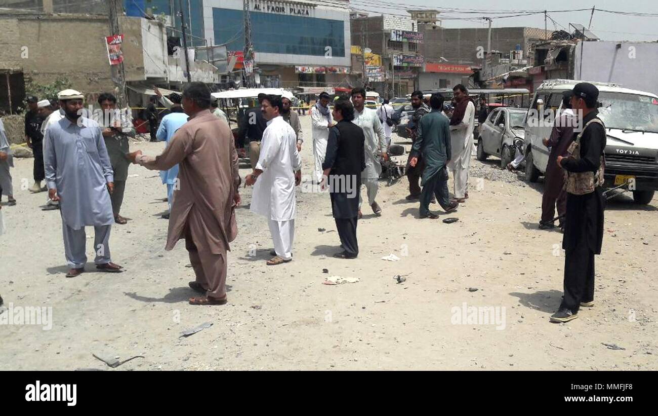 Bannu. 11th May, 2018. People gather at the blast site in northwest ...