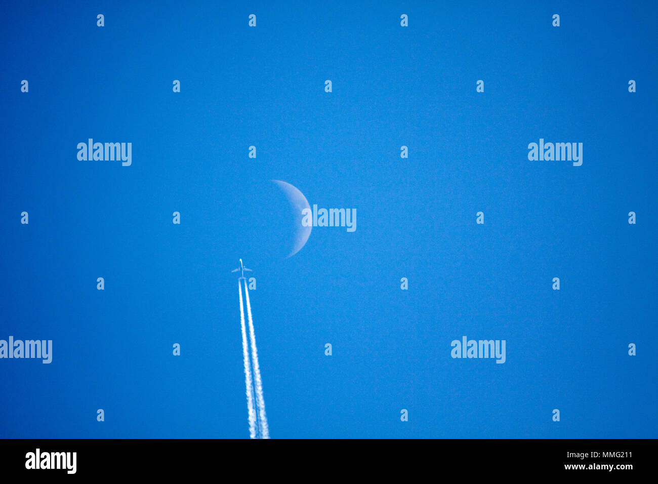 Airplane flying past moon hi-res stock photography and images - Alamy