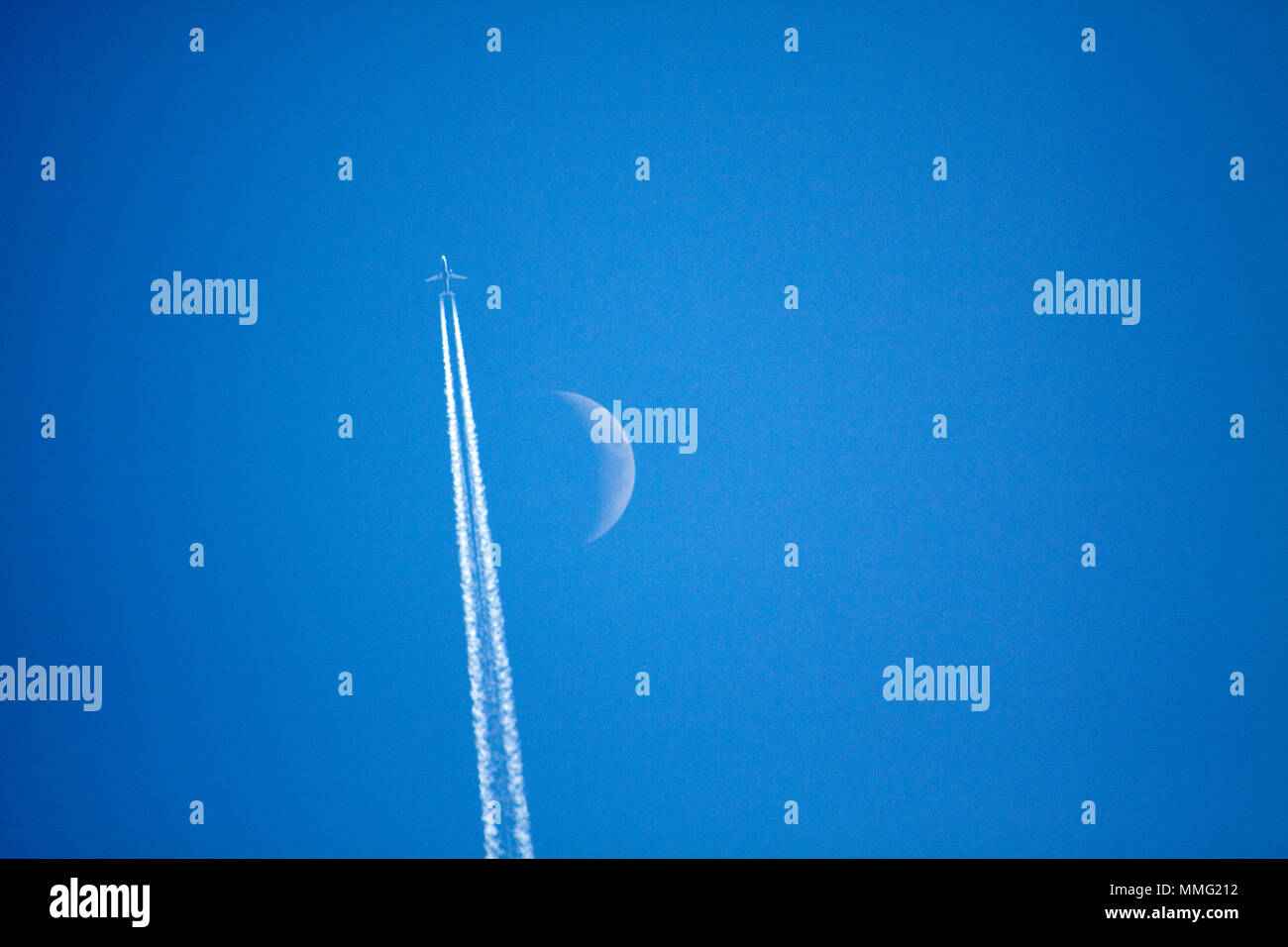 Airplane flying past moon hi-res stock photography and images - Alamy