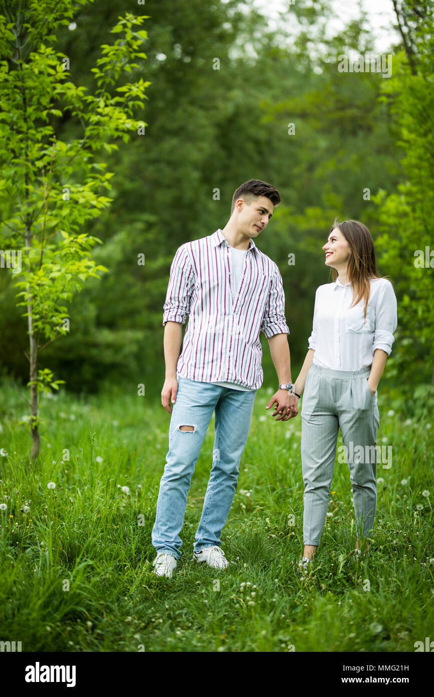 Beautiful couple taking a walk in city park Stock Photo - Alamy