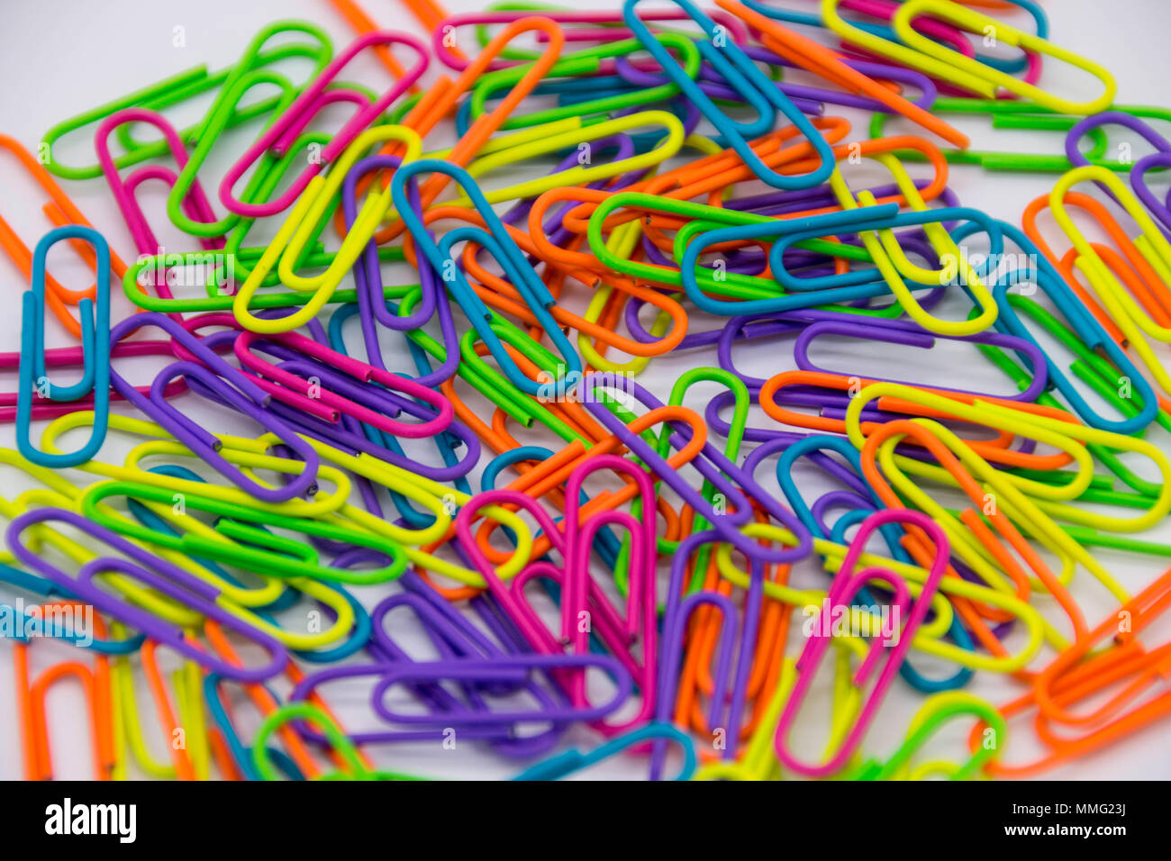Colourful neon paper clips / fasteners isolated on a white background ...