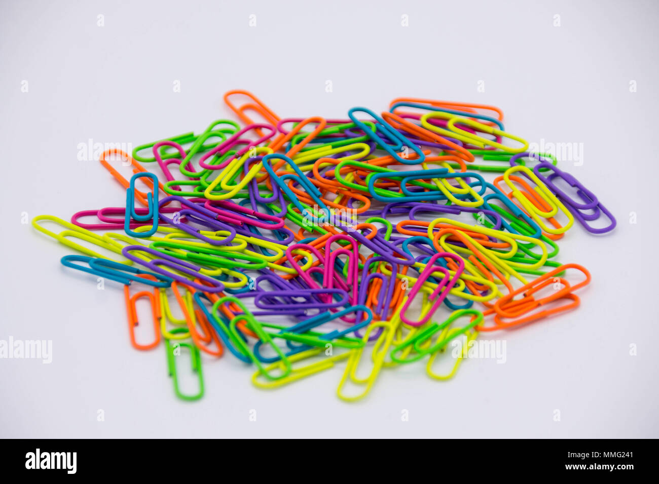 Colourful neon paper clips / fasteners isolated on a white background ...