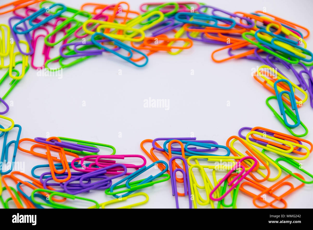 Colourful neon paper clips / fasteners isolated on a white background ...