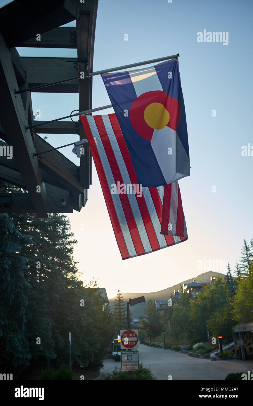 Two flags, the state flag for Colorado and the American national flag ...