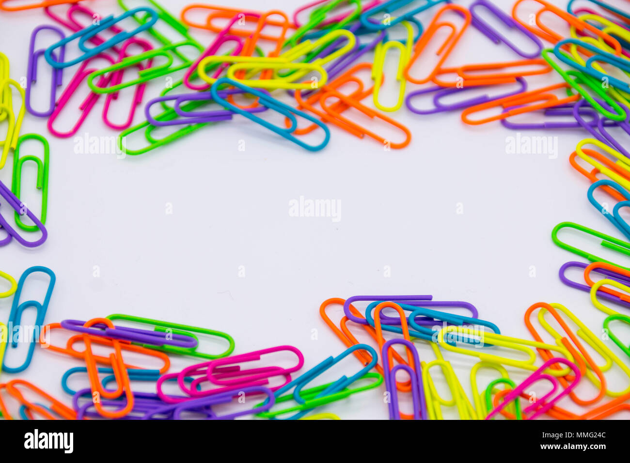 Colourful neon paper clips / fasteners isolated on a white background ...