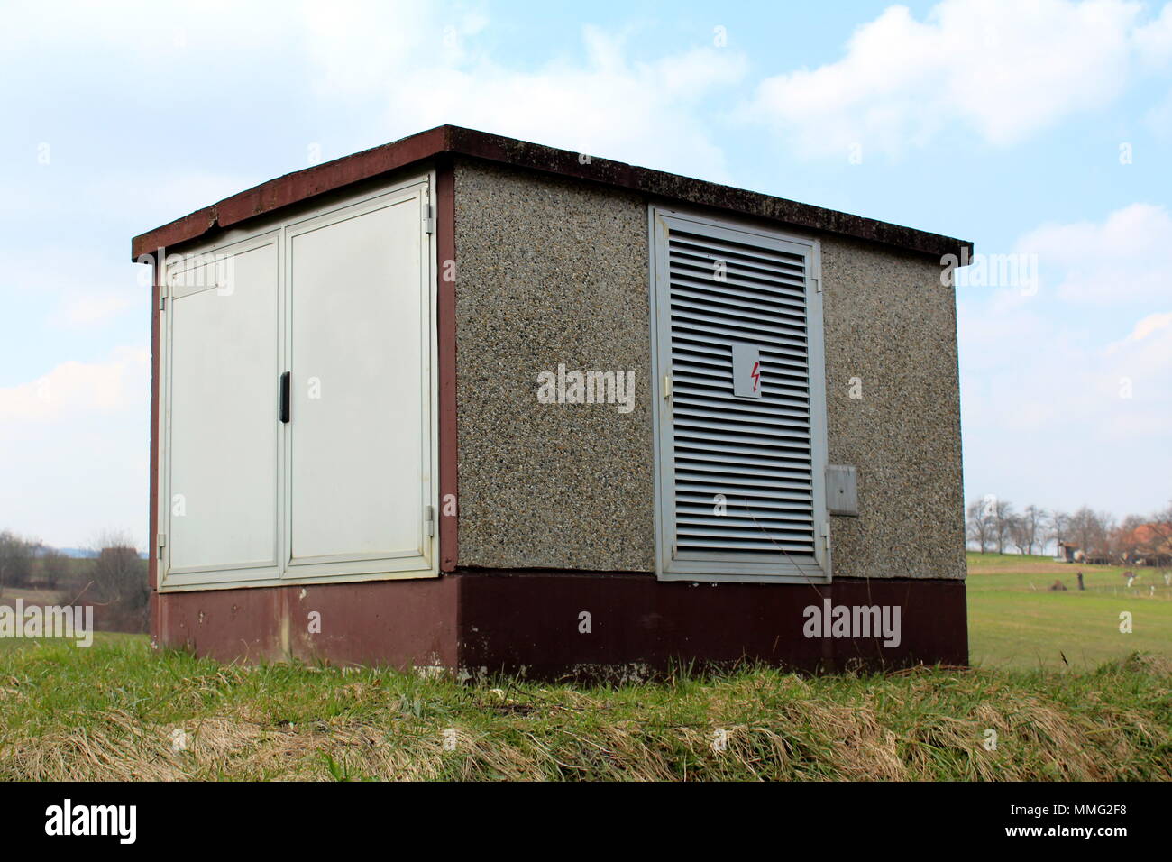 Outdoor concrete electrical high voltage box with two metal doors and ...